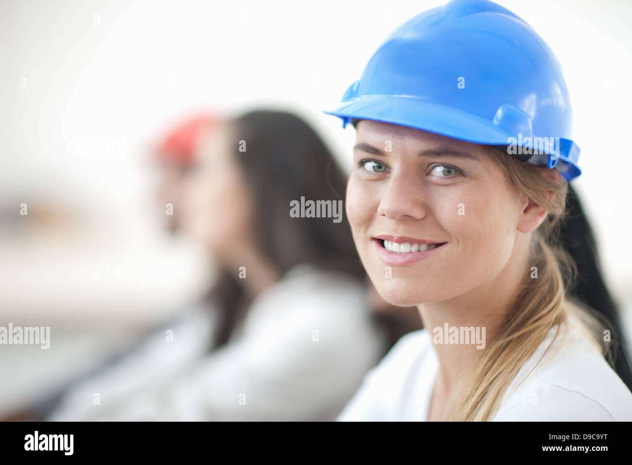 Female laborer smiling Stock Photo - Alamy