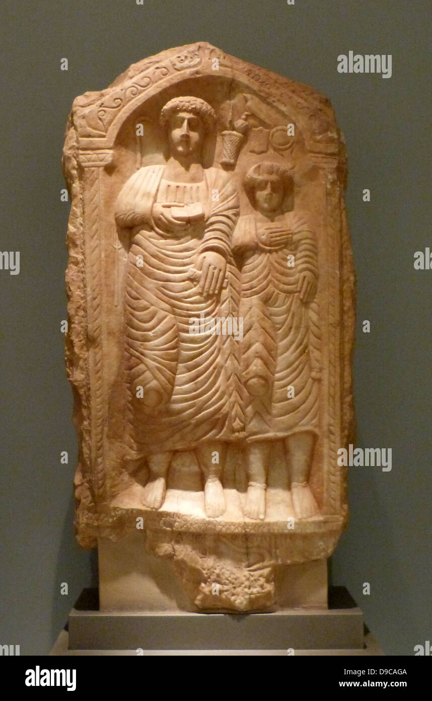 Marble inscribed grave relief. Represented is a couple in an arched ...