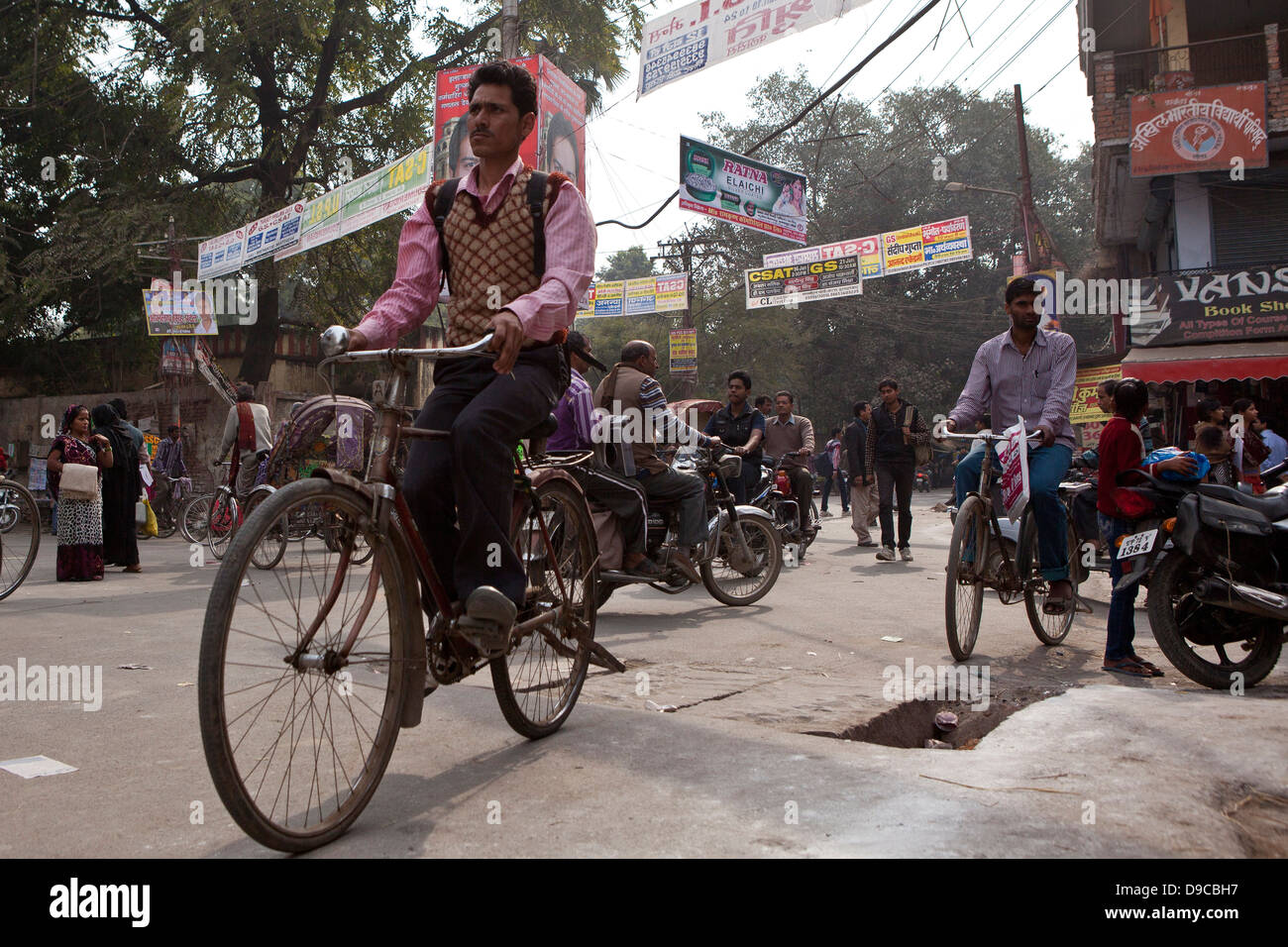 People riding bicycles on a street in India Stock Photo - Alamy