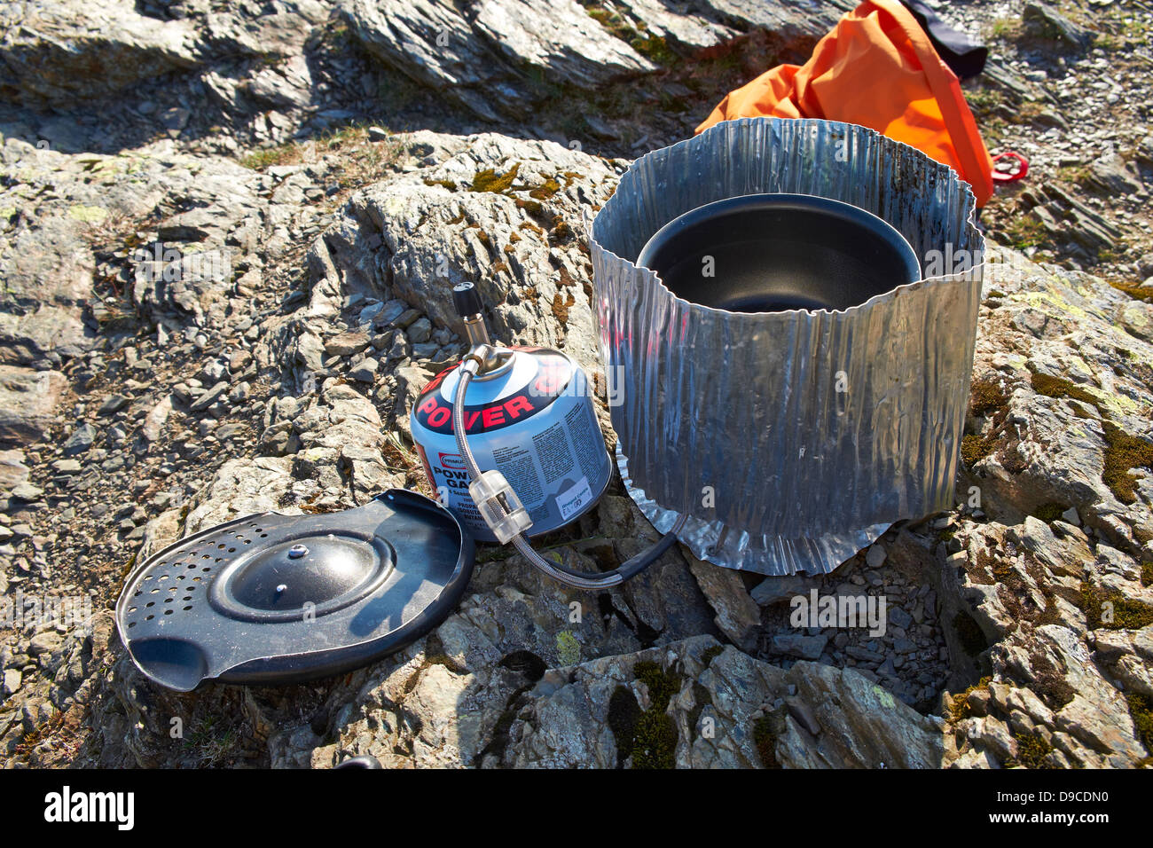 Cooking on a camping stove on the summit of a mountain in the Lake ...
