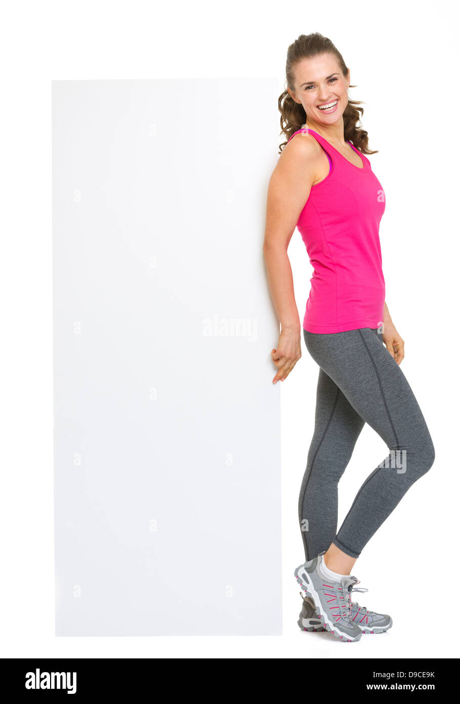 Happy fitness young woman showing blank billboard Stock Photo - Alamy Happy fitness young woman showing blank billboard Stock Photo - Alamy