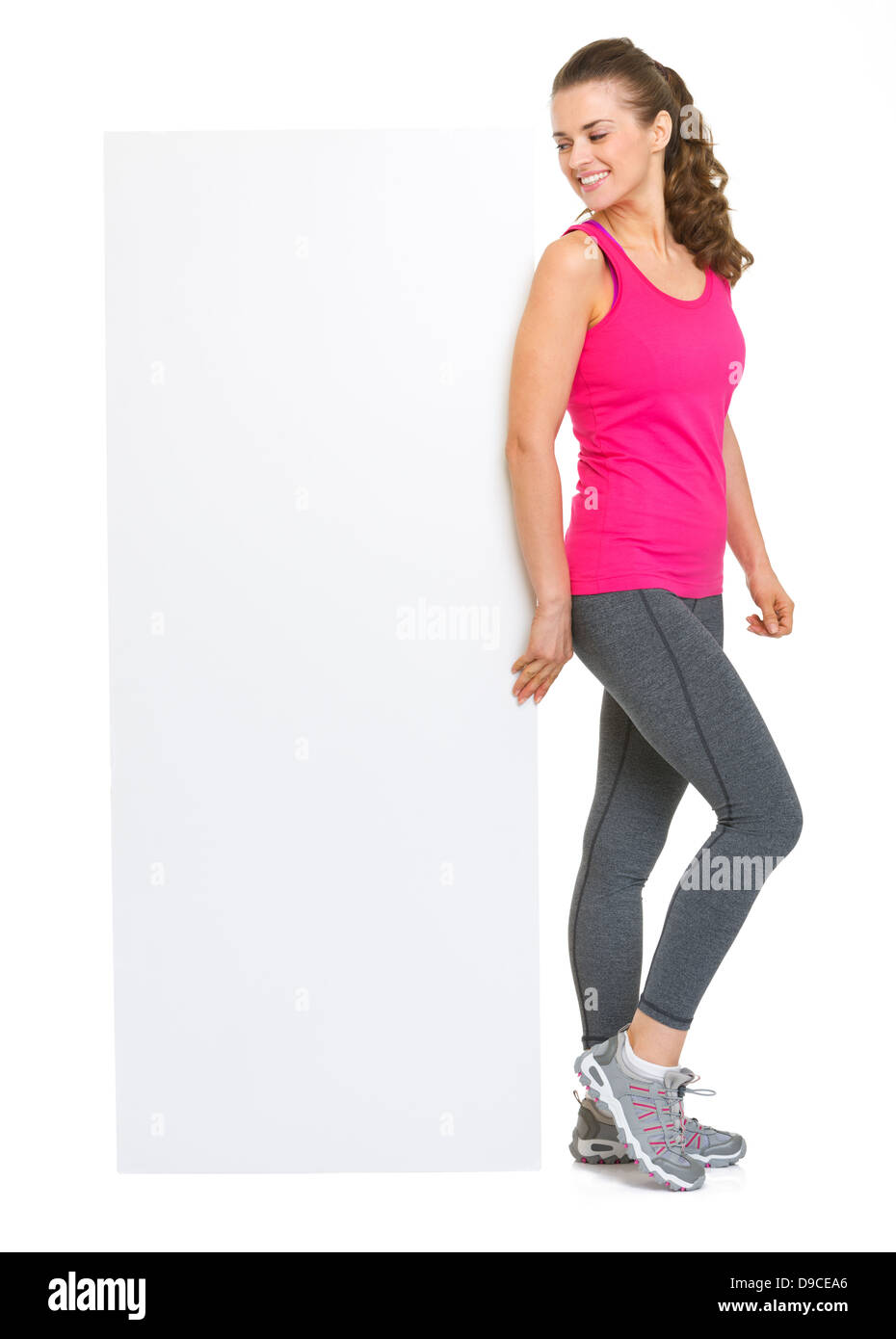 Happy fitness young woman looking on blank billboard Stock Photo - Alamy Happy fitness young woman looking on blank billboard Stock Photo - Alamy