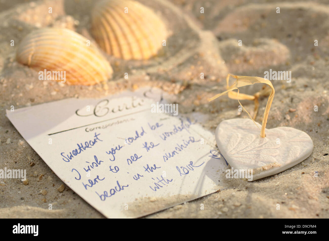 Heart with postcard and sea shells on the beach Stock Photo - Alamy