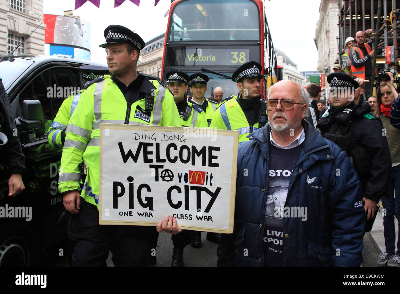 Protester with placard stands in front of police line during G8 ...