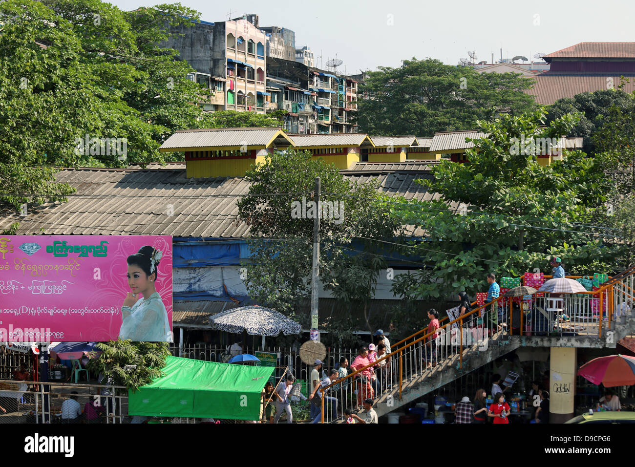 Street view of market, apartment buildings, pedestrian overpass, and ...