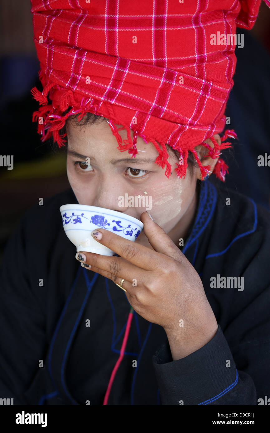 Young woman wearing Thanaka face creme and red cloth turban from Shan ...
