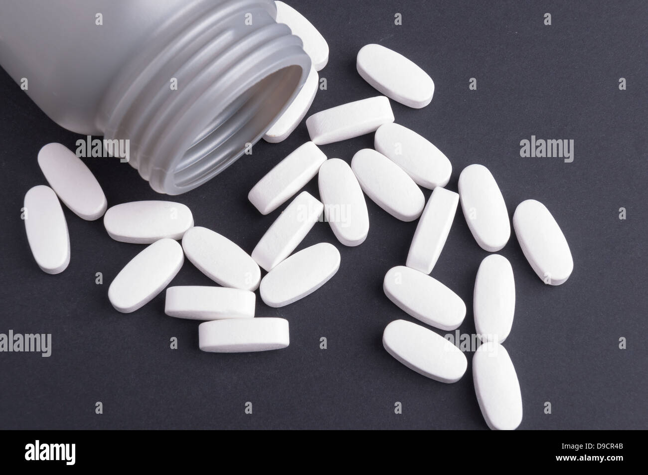 Recipient of medication pills on black background Stock Photo - Alamy