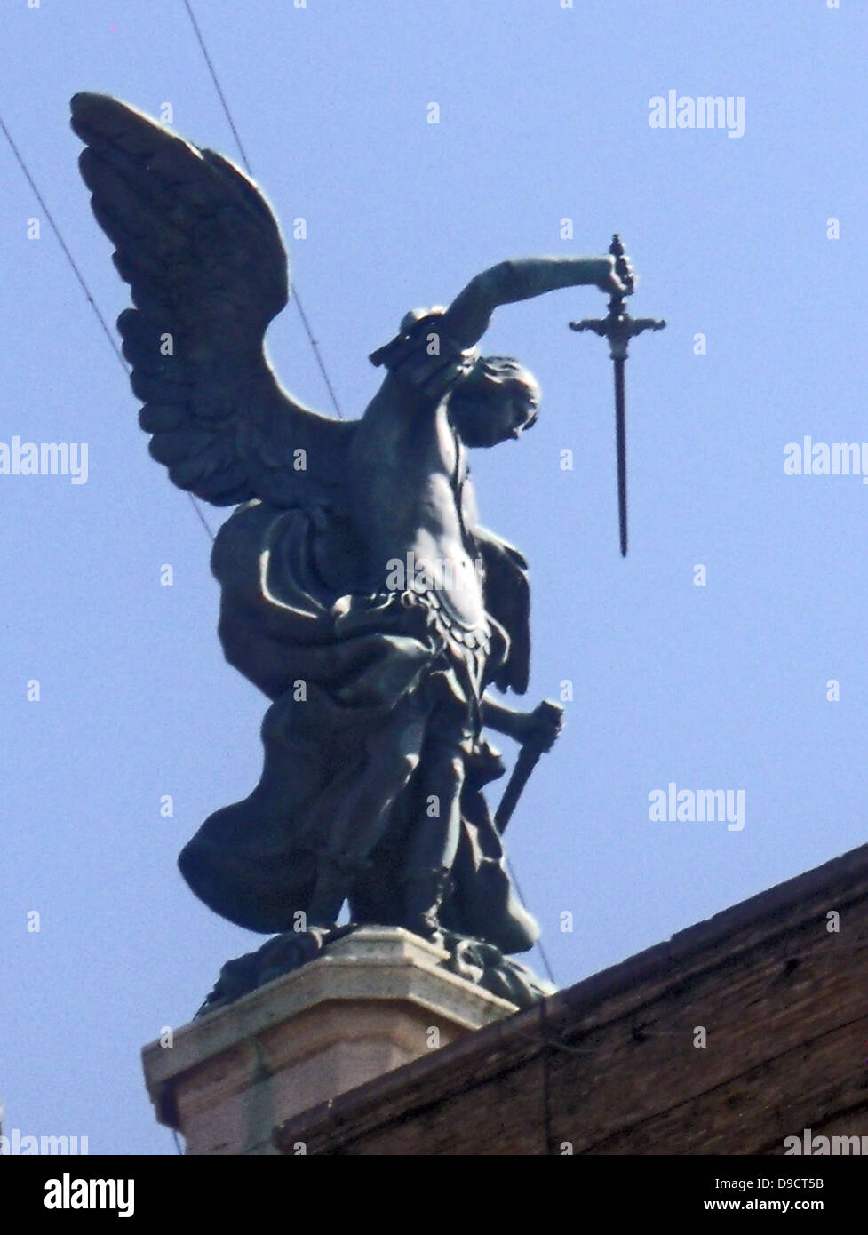 The bronze statue of Archangel Michael, standing on top of the castle ...