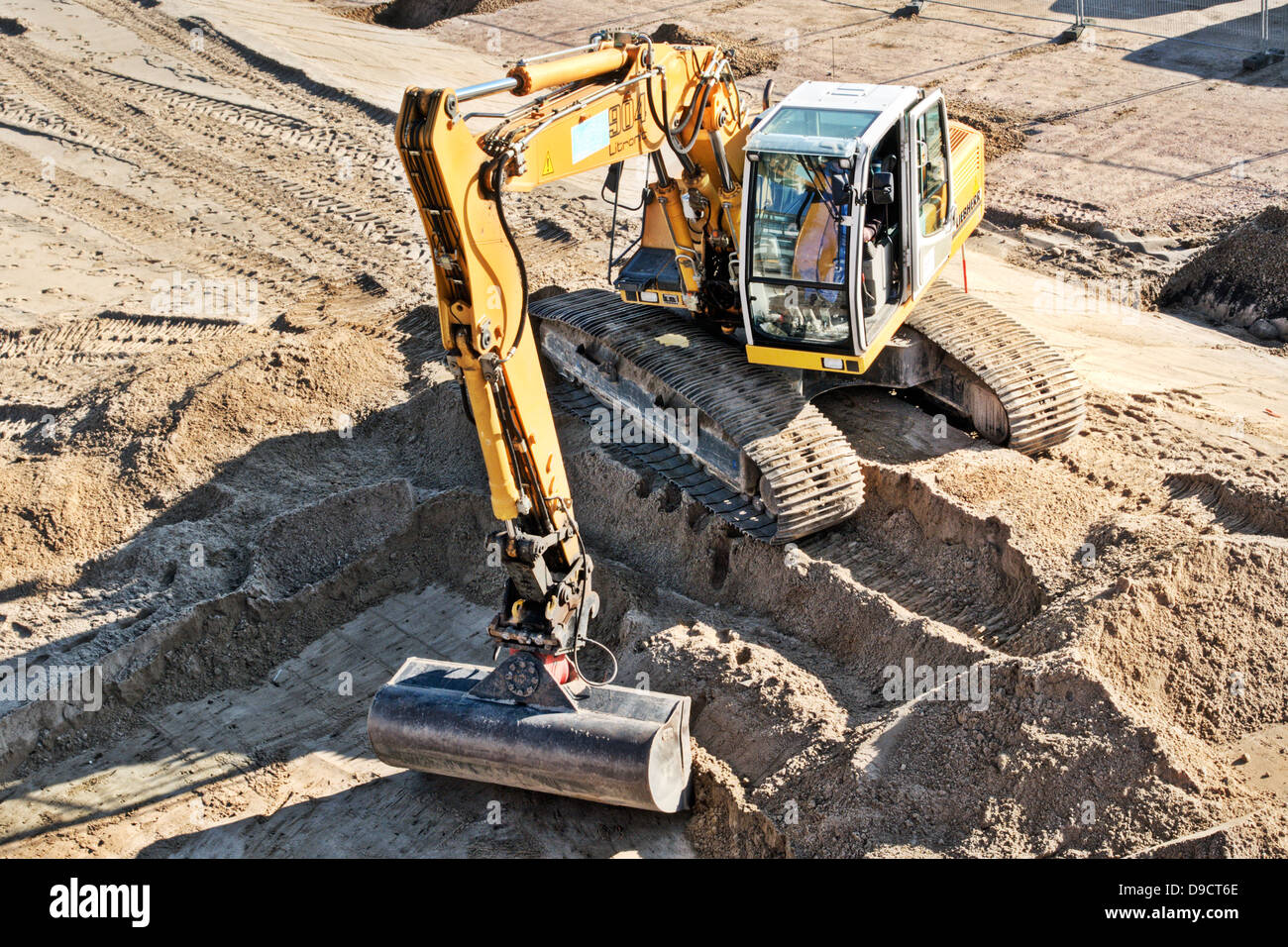 Excavator on a building site Stock Photo - Alamy