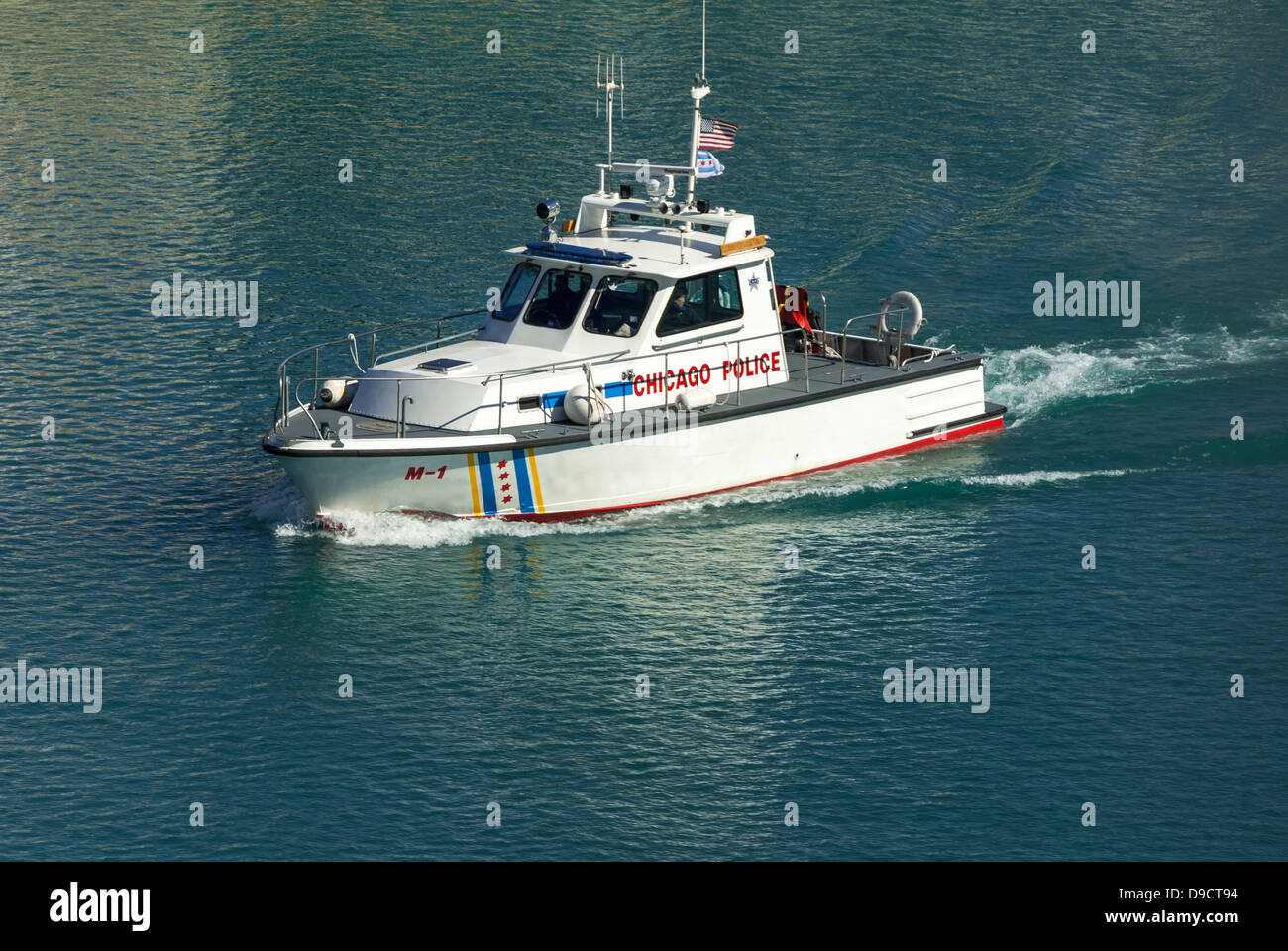 Chicago police boat on patrol with highlights reflected in the water ...