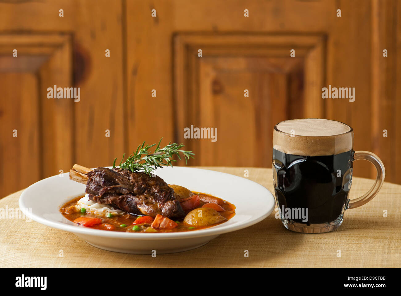 Lamb Shank and a beer at a pub Stock Photo - Alamy