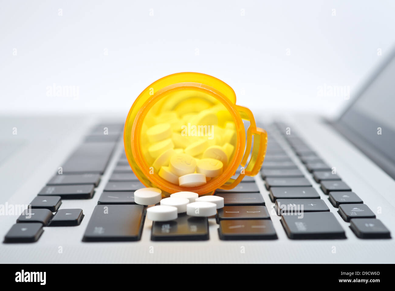 Online prescription order concept with bottles of medicine on keyboard ...