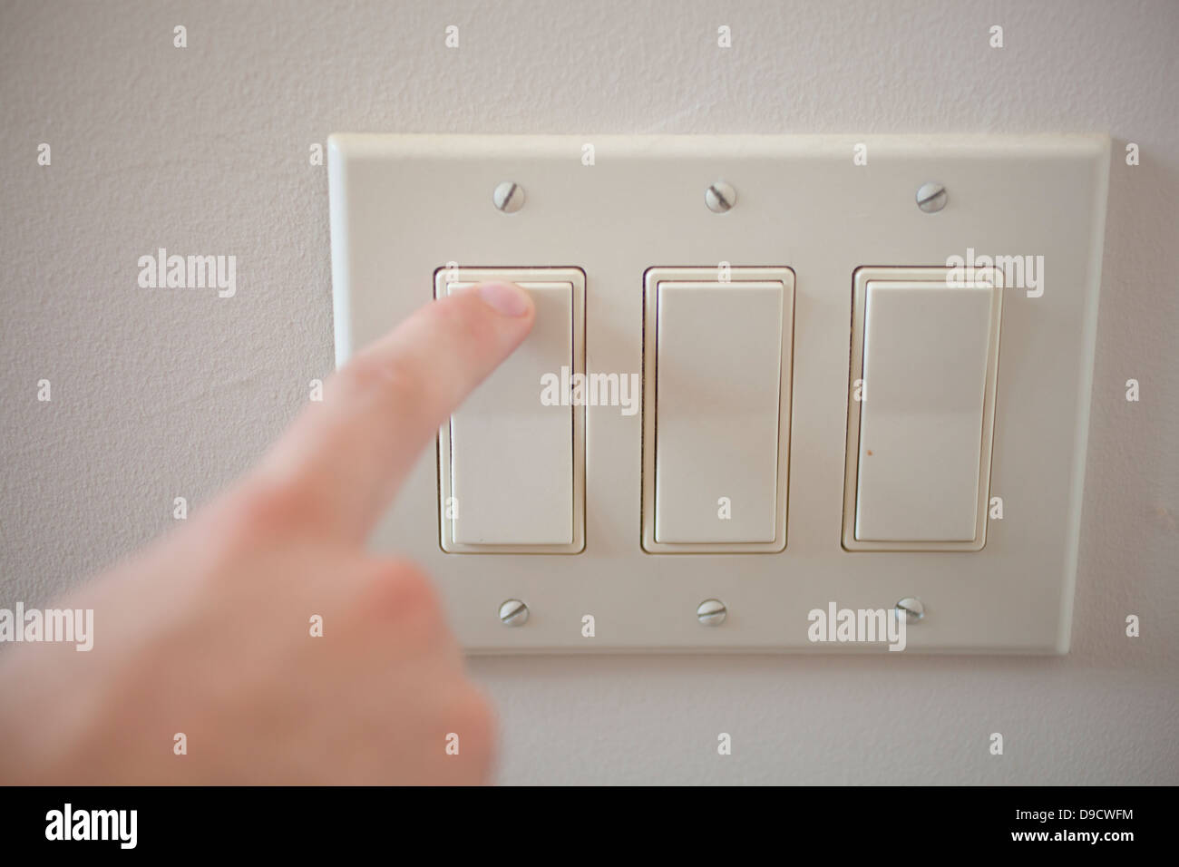 A finger switching off a light switch Stock Photo - Alamy