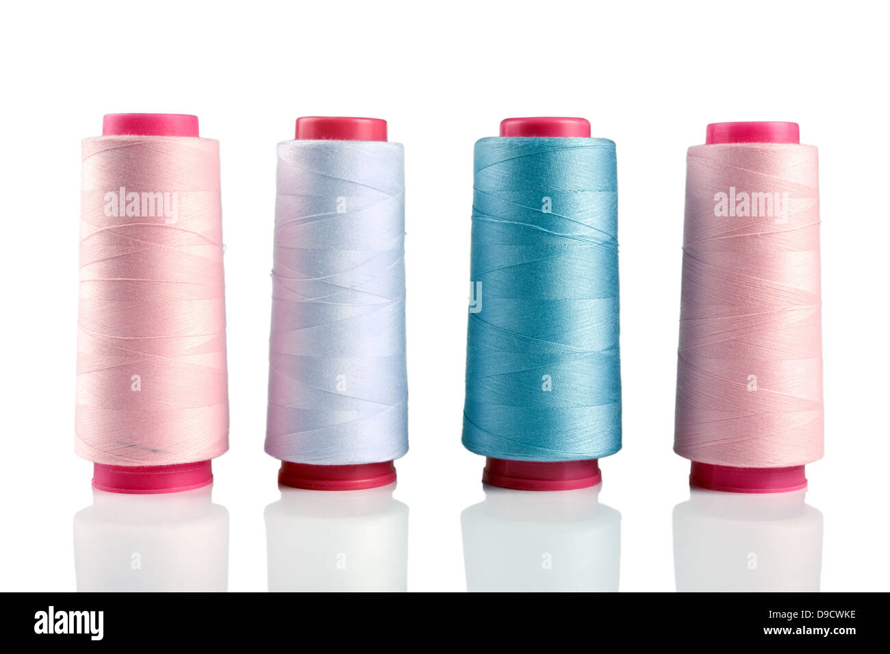 Some plastic spools with multicoloured threads isolated on white Stock ...