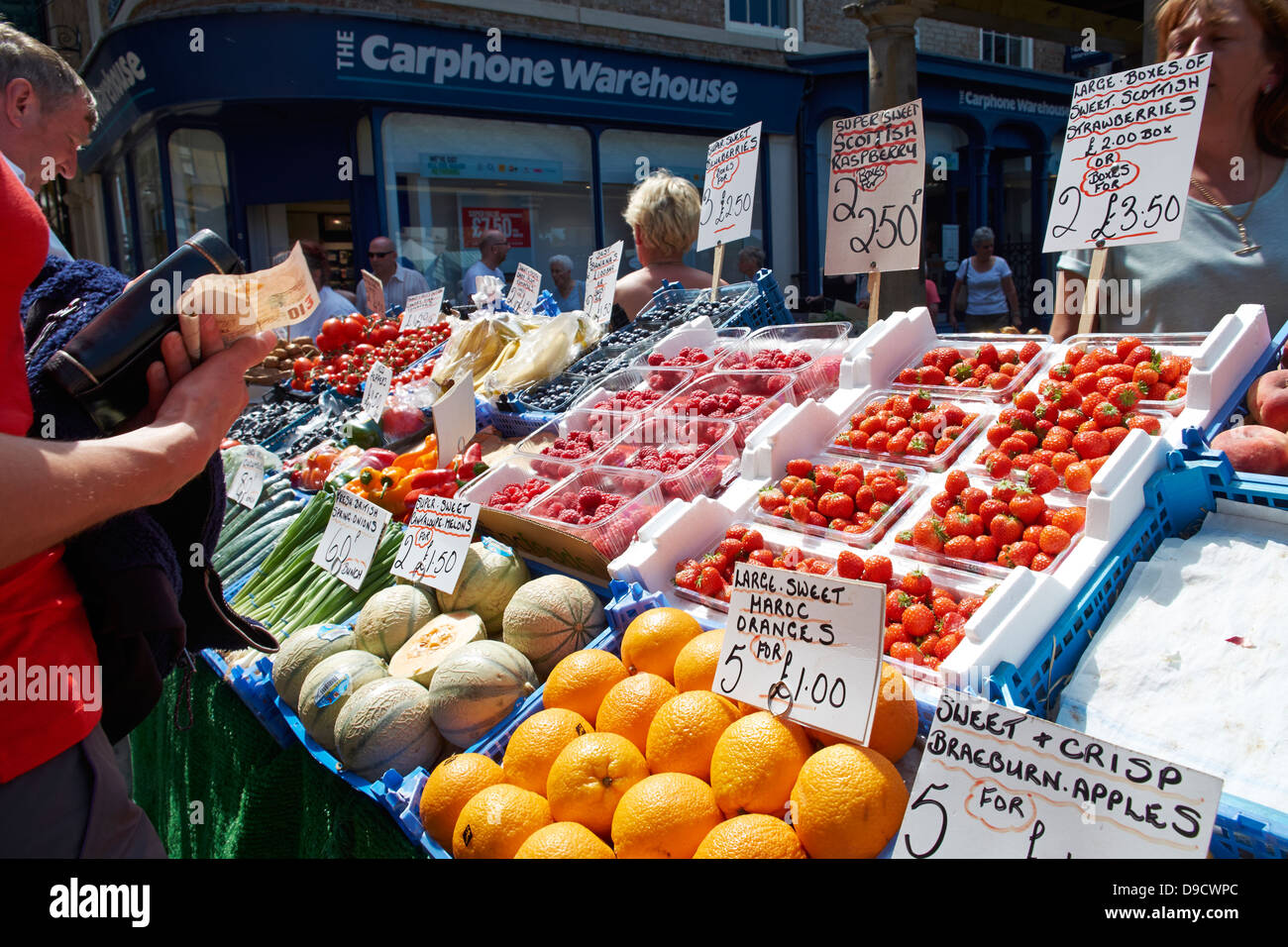 Buying Fruit and veg at a market stall Stock Photo - Alamy