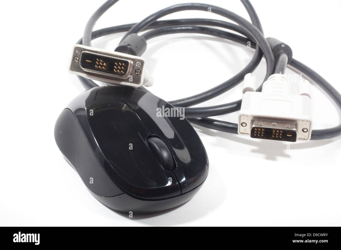 A black wireless mouse and a VGA cable isolated against a white ...