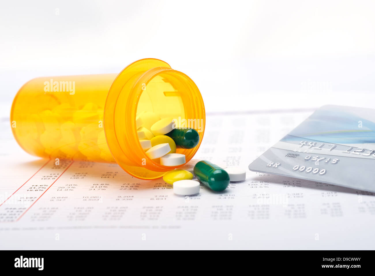 Pills and credit card on account paper background Stock Photo - Alamy