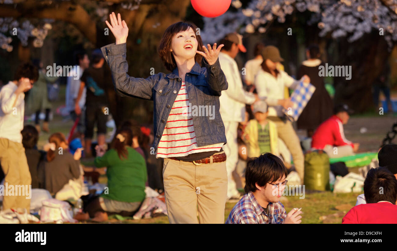 Young Japanese Female participating in a ball game during Hanami ...