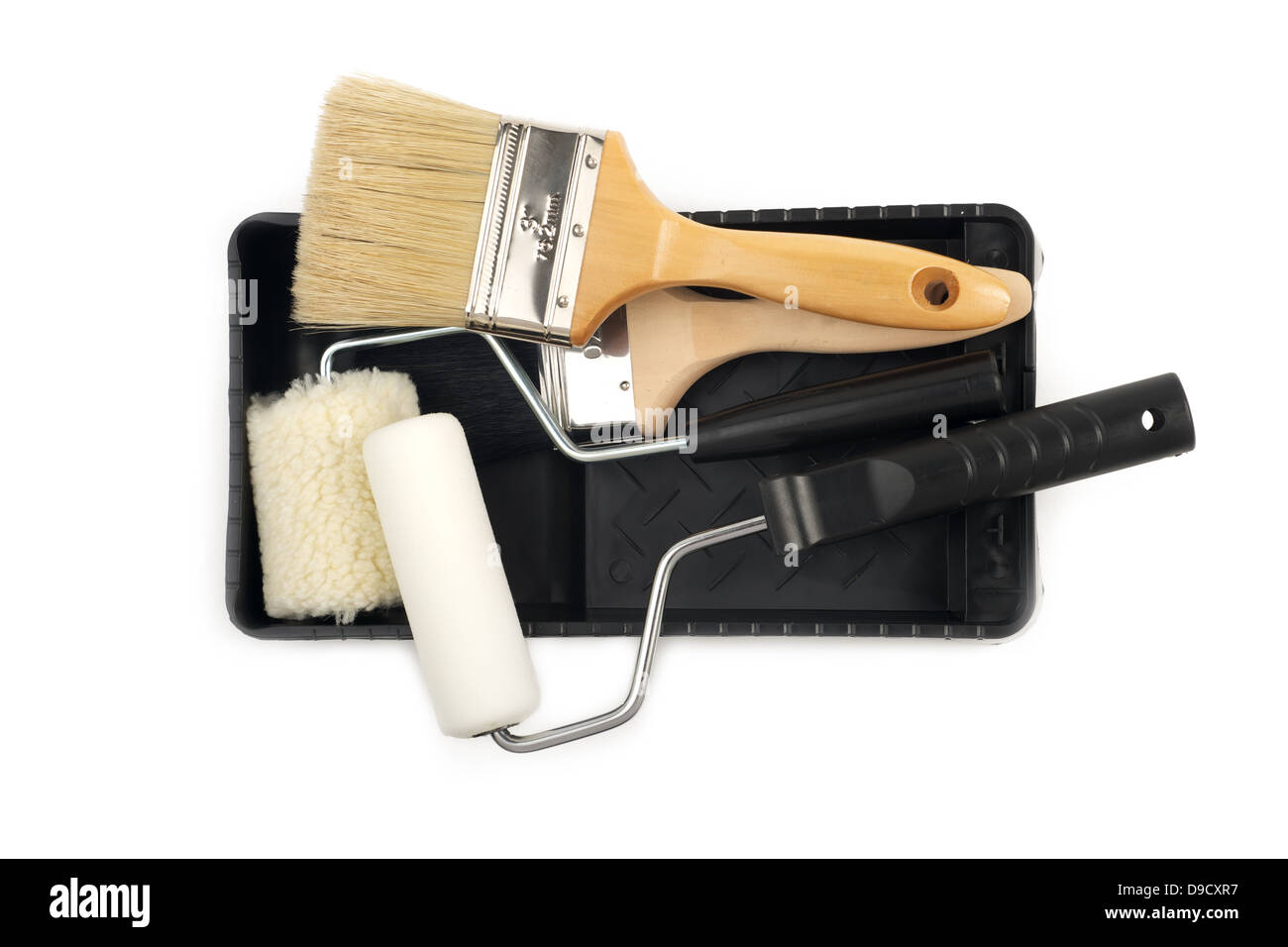 Paint rollers and brush on black tray Stock Photo - Alamy