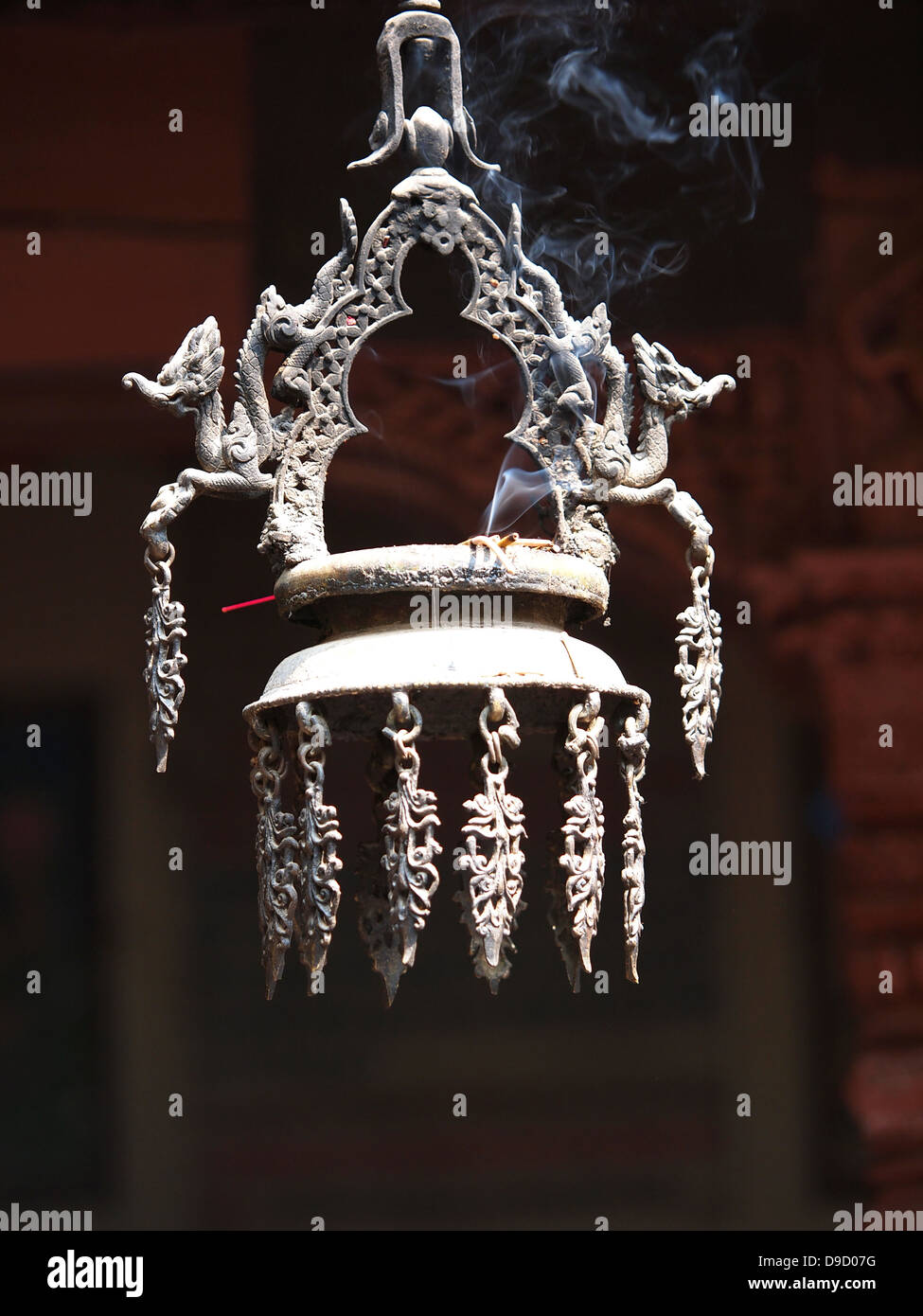 smoking incense on a bell in the buddhist temple Stock Photo - Alamy