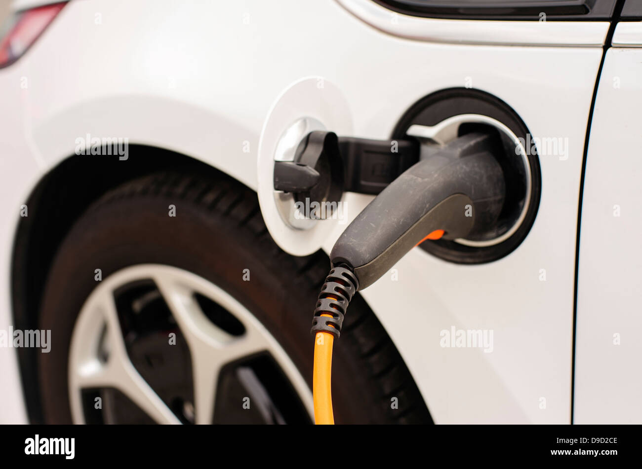 Electric car connected to power supply Stock Photo - Alamy