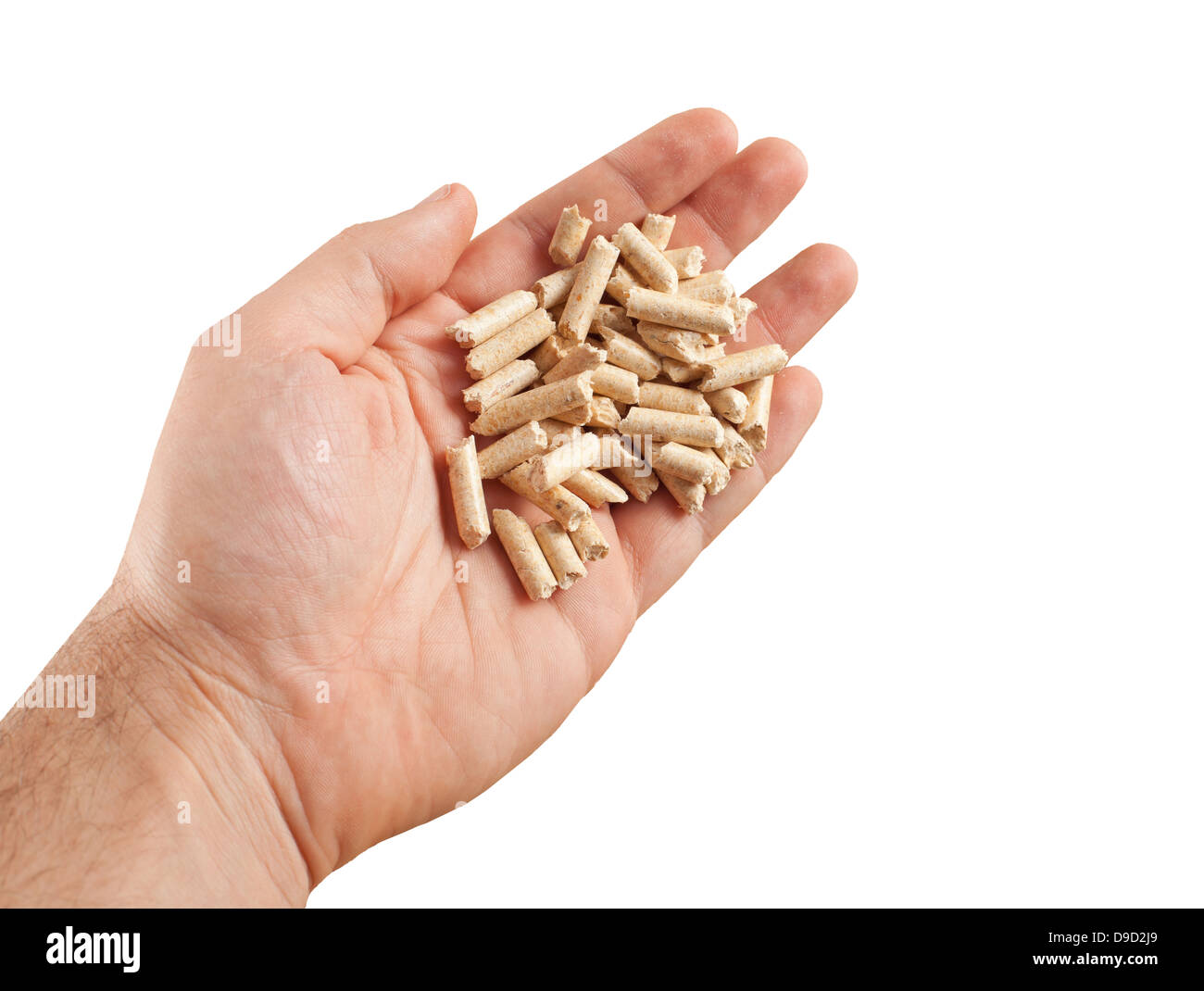 Wood pellets in hand on white background Stock Photo - Alamy