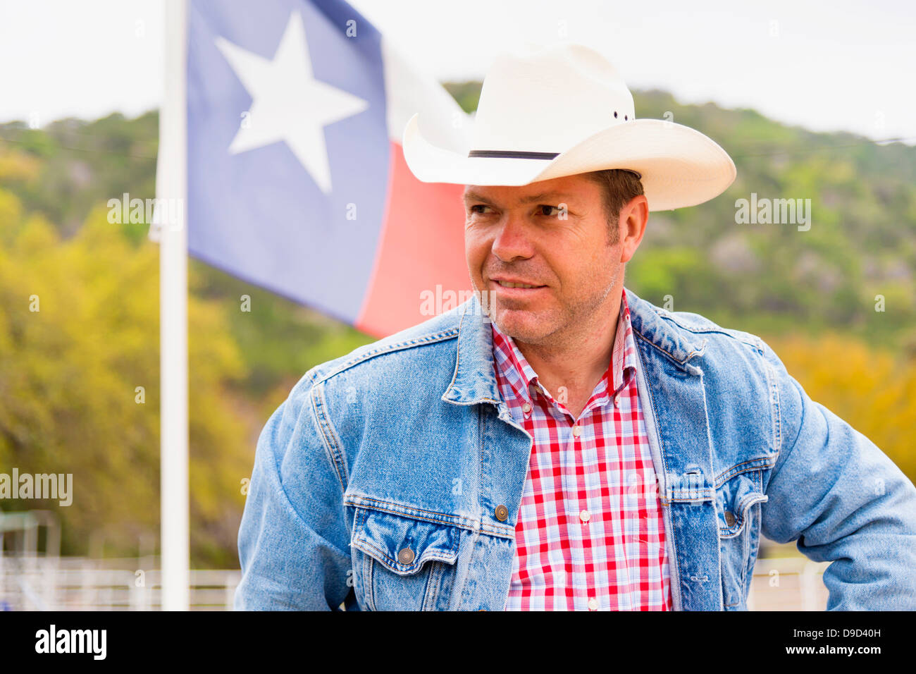 Texas, Mature man standing in front of flag with cowboy hat Stock Photo ...
