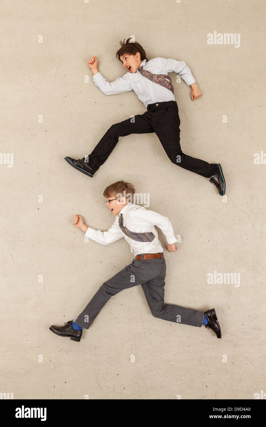 Business boys running in opposite direction Stock Photo - Alamy