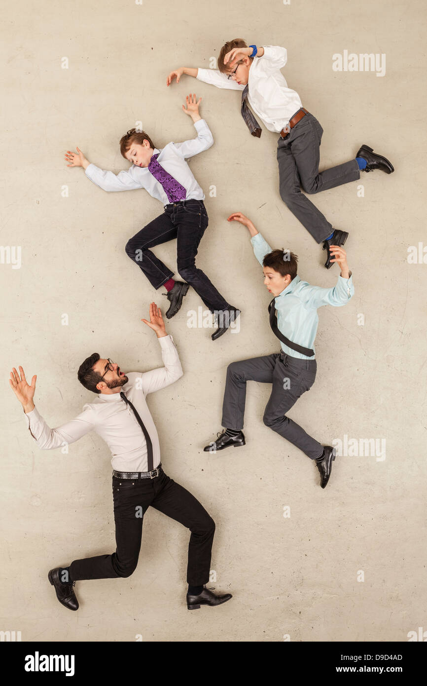 Businessman and boys flying in office Stock Photo - Alamy
