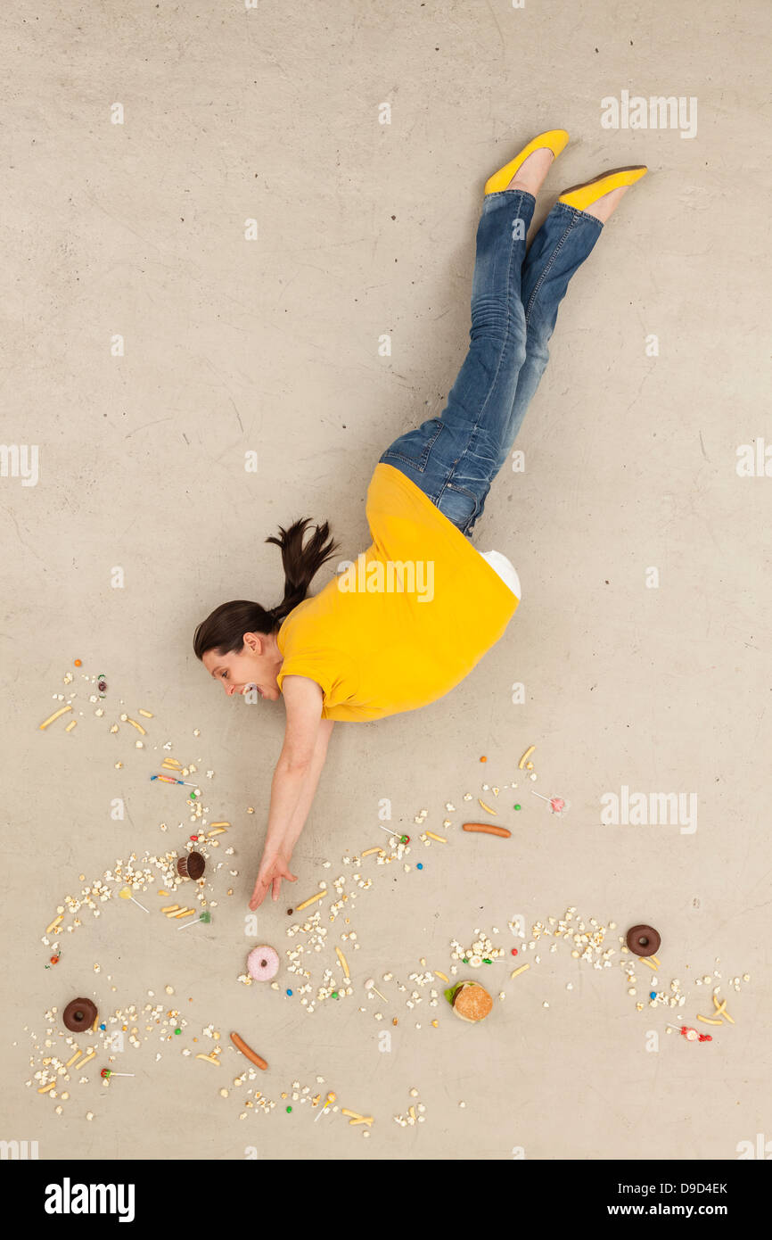 Woman falling in between food Stock Photo - Alamy