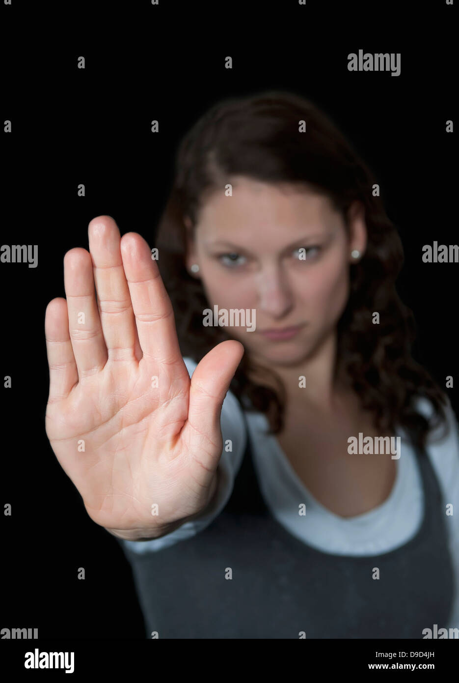 Angry young woman showing stop gesture, close up Stock Photo - Alamy