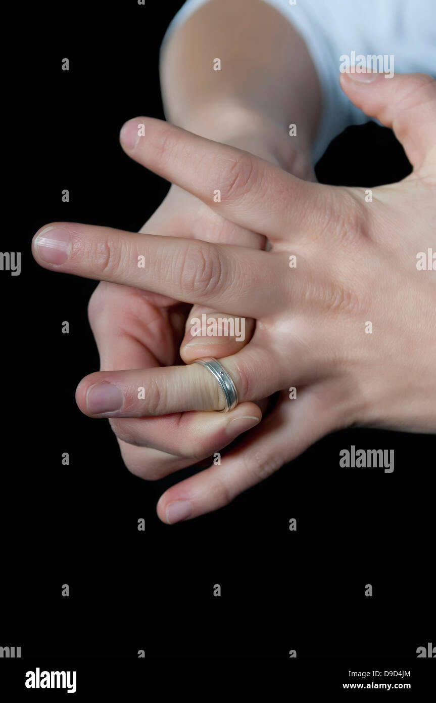 Young woman pulling ring from her finger, close up Stock Photo - Alamy