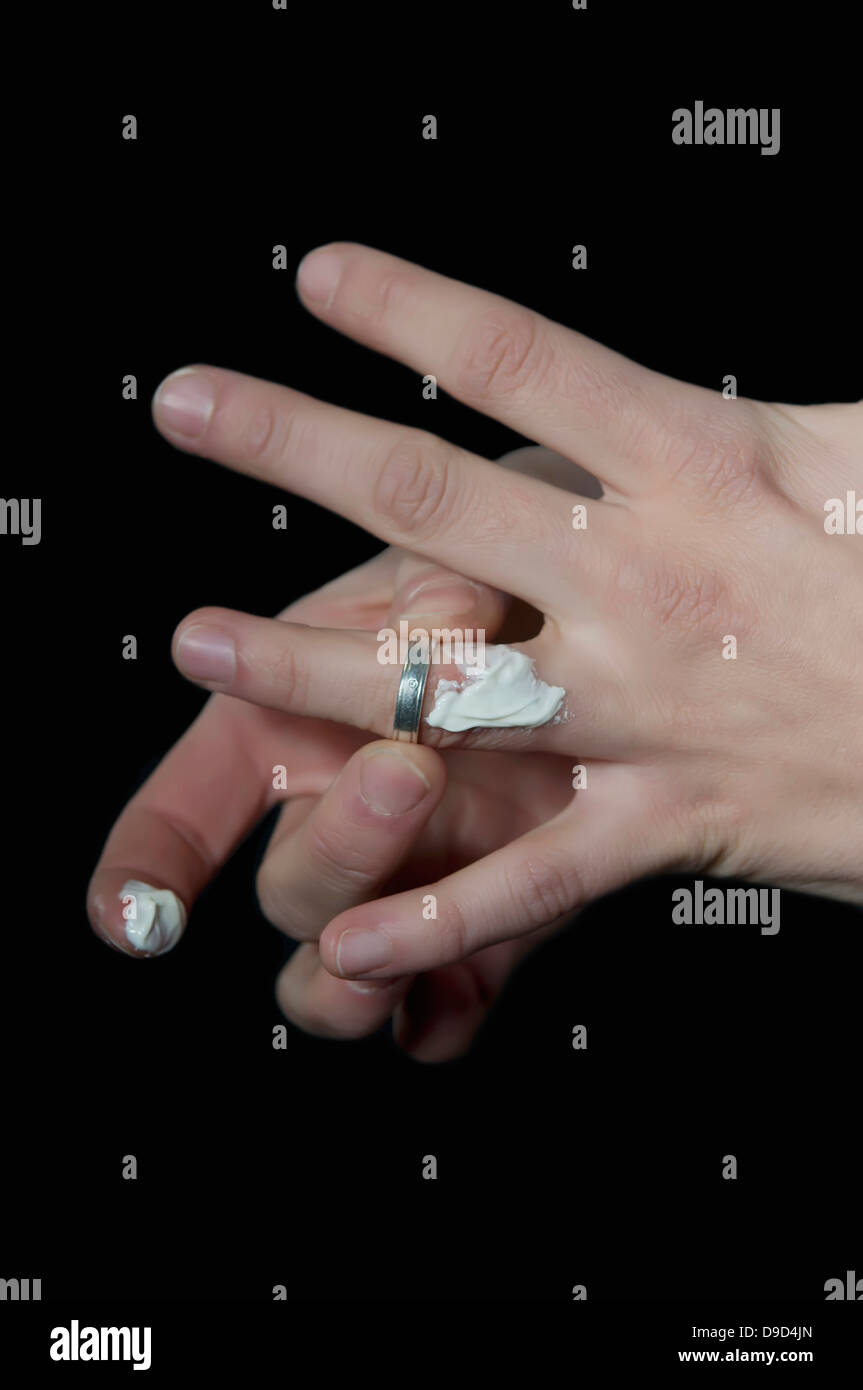 Young woman pulling ring from her finger with cream, close up Stock ...