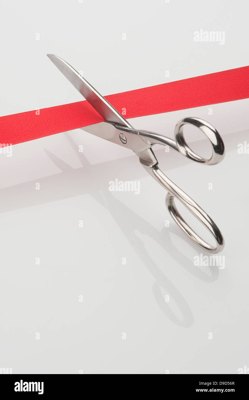 Scissors cutting inauguration red ribbon, close-up Stock Photo - Alamy