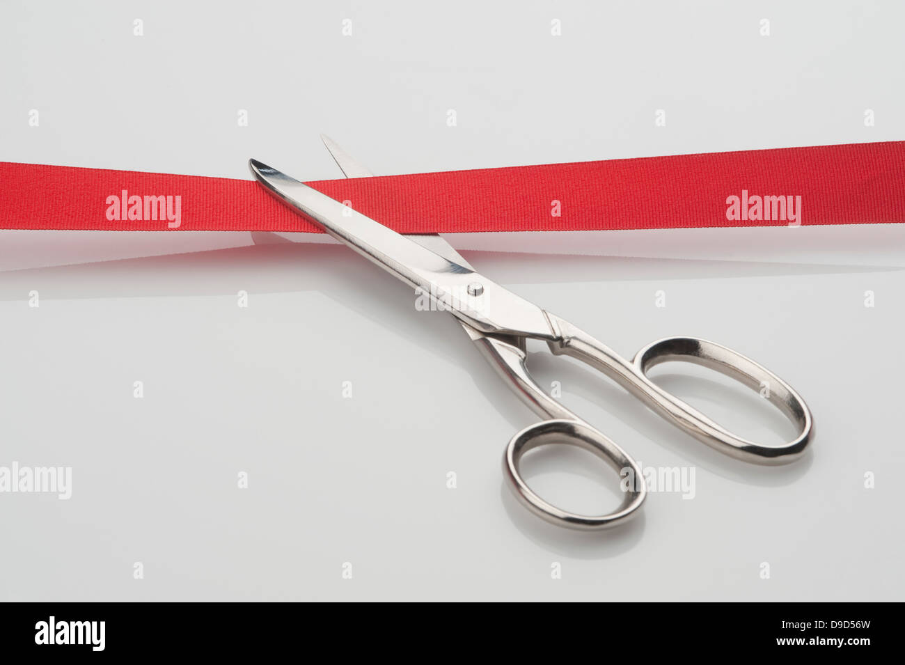 Scissors cutting inauguration red ribbon, close-up Stock Photo - Alamy