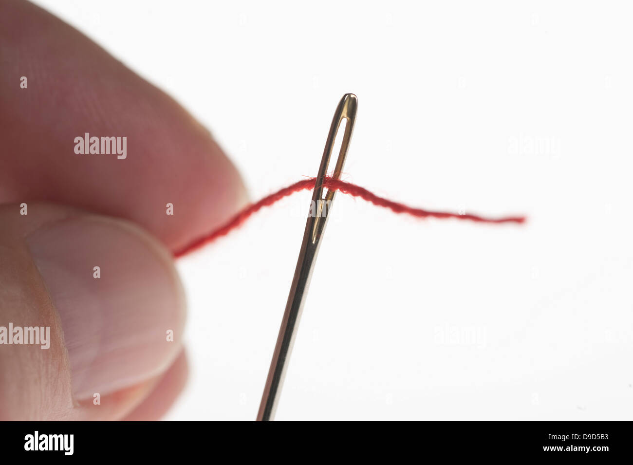Thread through needle hi-res stock photography and images - Alamy