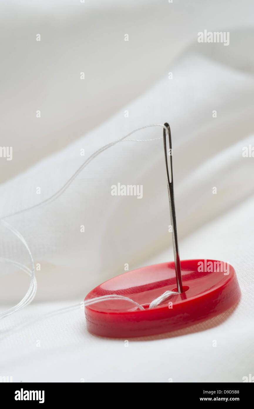 Button and needle hi-res stock photography and images - Alamy