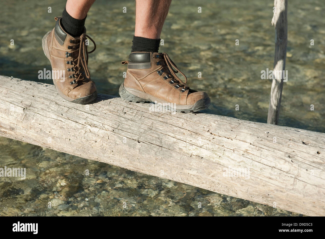 Germany, Bavaria, Man walking on tree trunk Stock Photo - Alamy