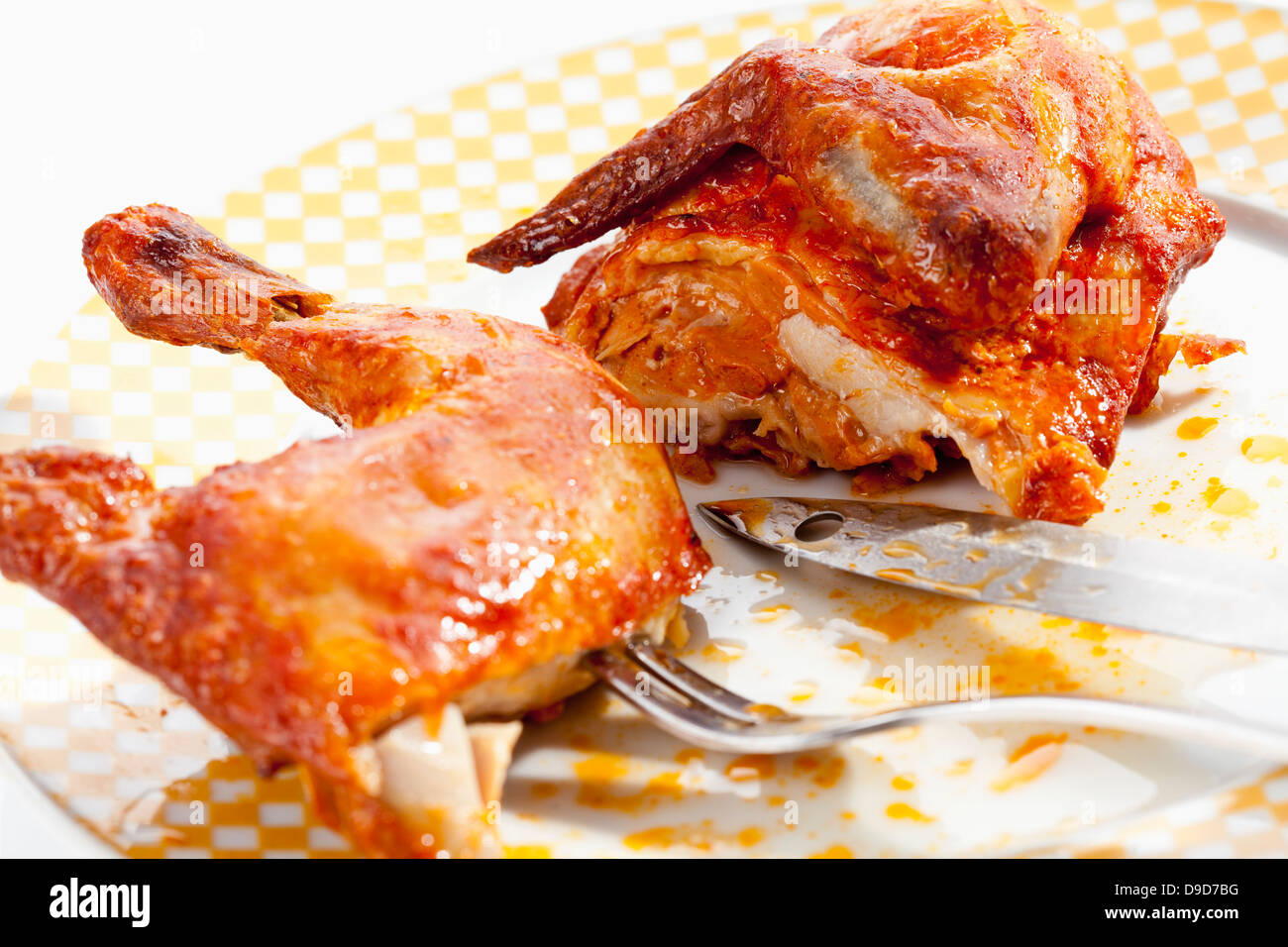 Plate of half roasted chicken, close up Stock Photo - Alamy