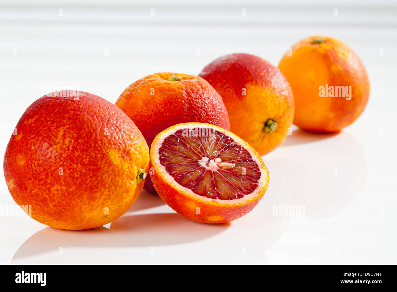 Blood oranges with juice extractor on white background, close up Stock ...