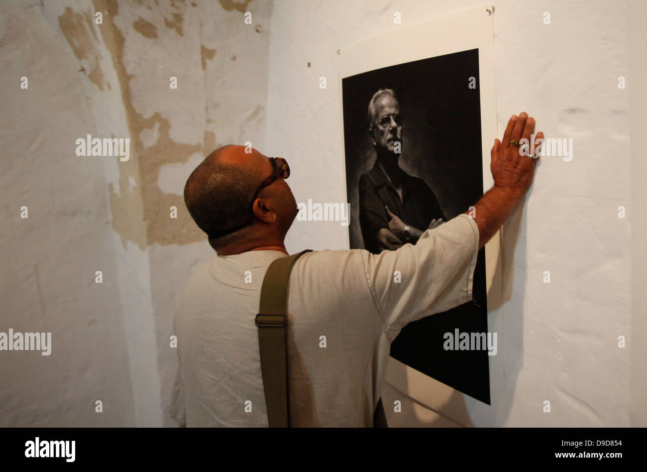 A visitor inspects carefully a photograph by Avhalom Levy depicting an ...