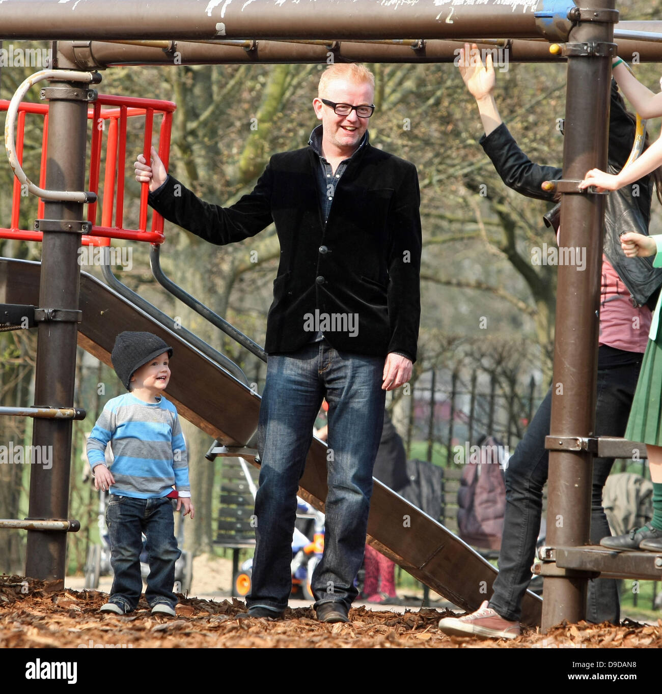 Chris Evans and son Noah watch Natasha climb the monkey bars whilst playing at the park together ...