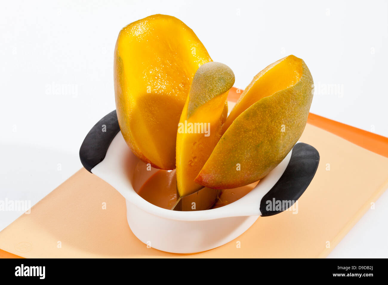 Mango with spliter on white background, close up Stock Photo - Alamy