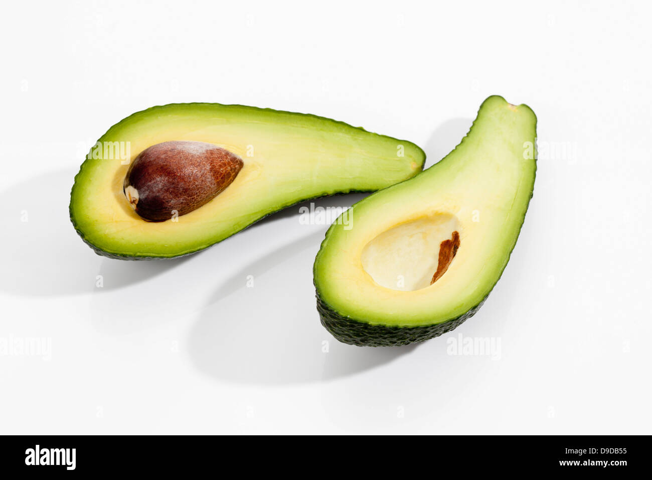 Cross section of avocados on white background, close up Stock Photo - Alamy