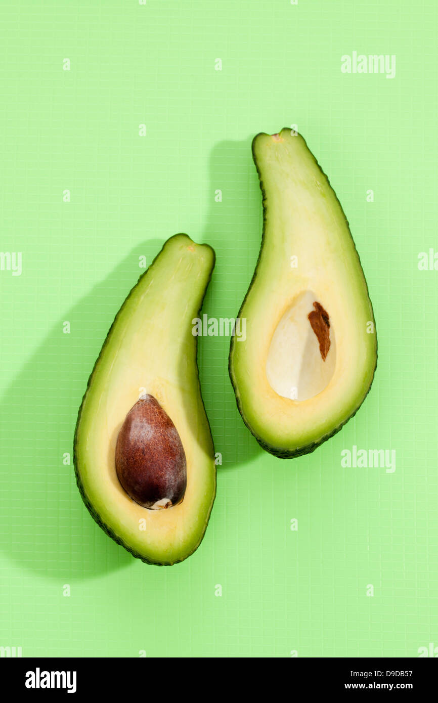 Cross section of avocados on chopping board Stock Photo - Alamy