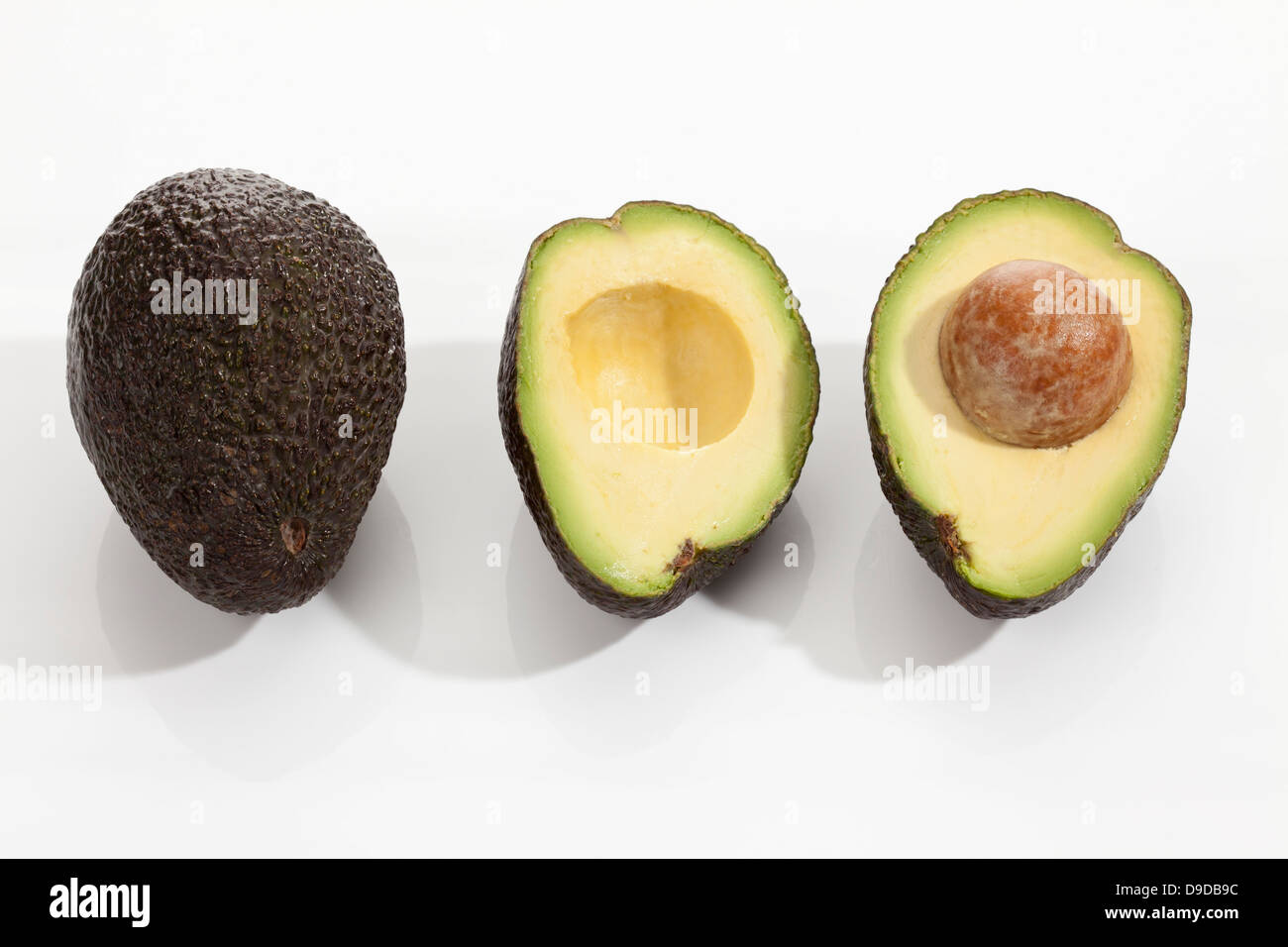 Whole and halved avocado ripe on white background, close up Stock Photo ...