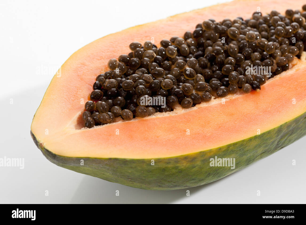 Cross section of papaya on white background, close up Stock Photo - Alamy