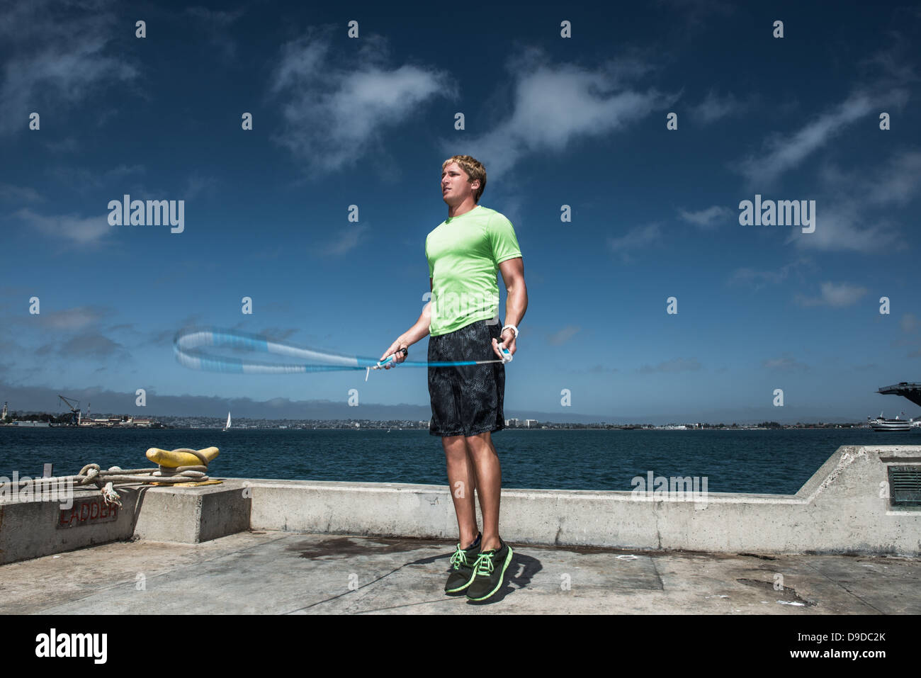 Young man using skipping rope hi-res stock photography and images - Alamy