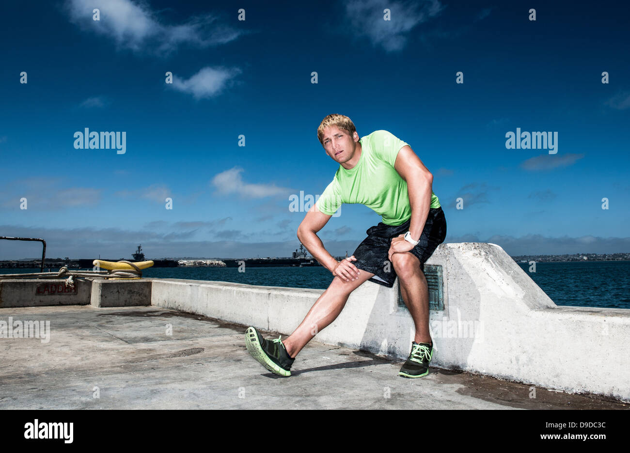 Young man warming up before exercise Stock Photo - Alamy