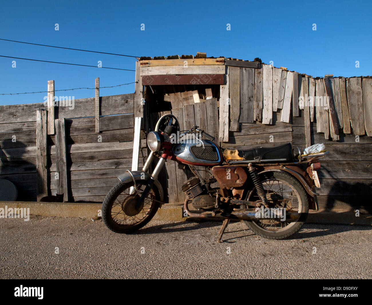 An old motorbike outside a wooden shack in Portugal Stock Photo - Alamy